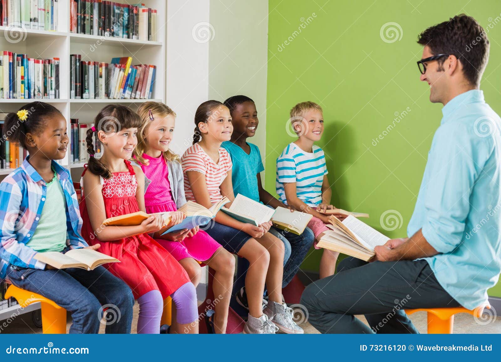 Teacher Teaching Kids in Library Stock Photo - Image of adult, academic ...