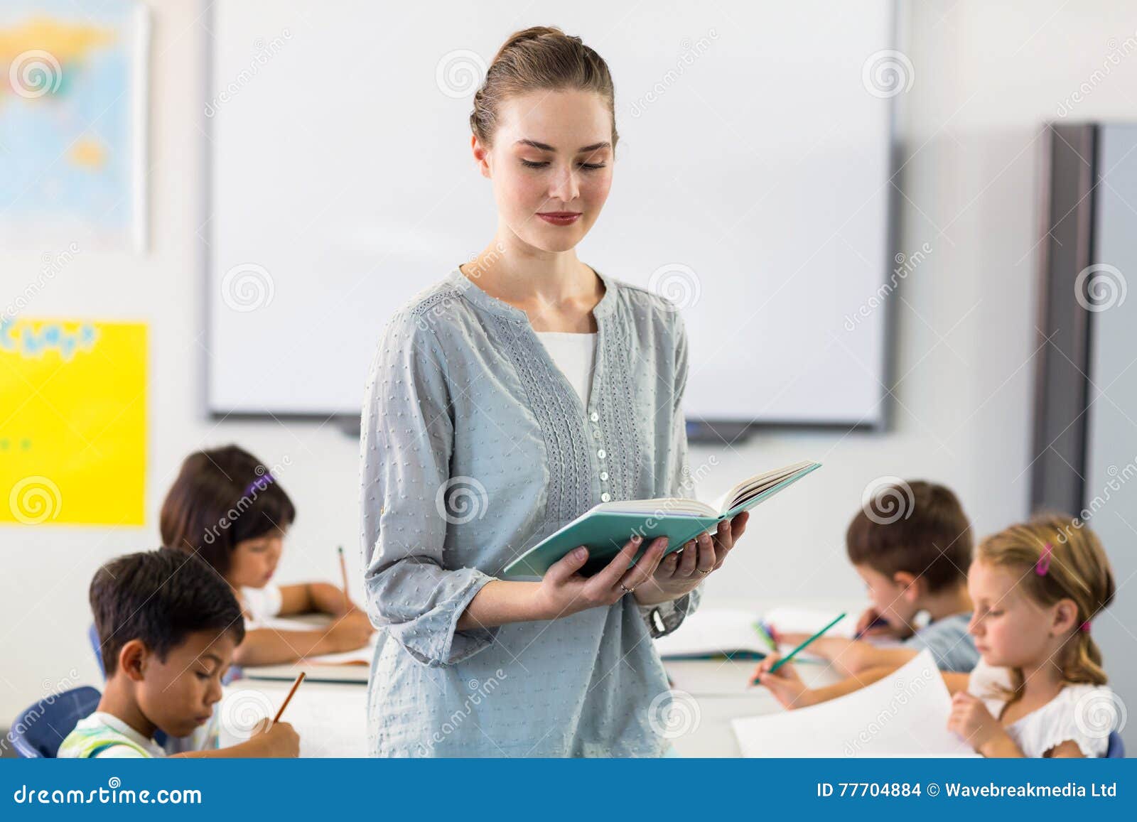 Teacher Teaching Students in Classroom Stock Photo - Image of book ...