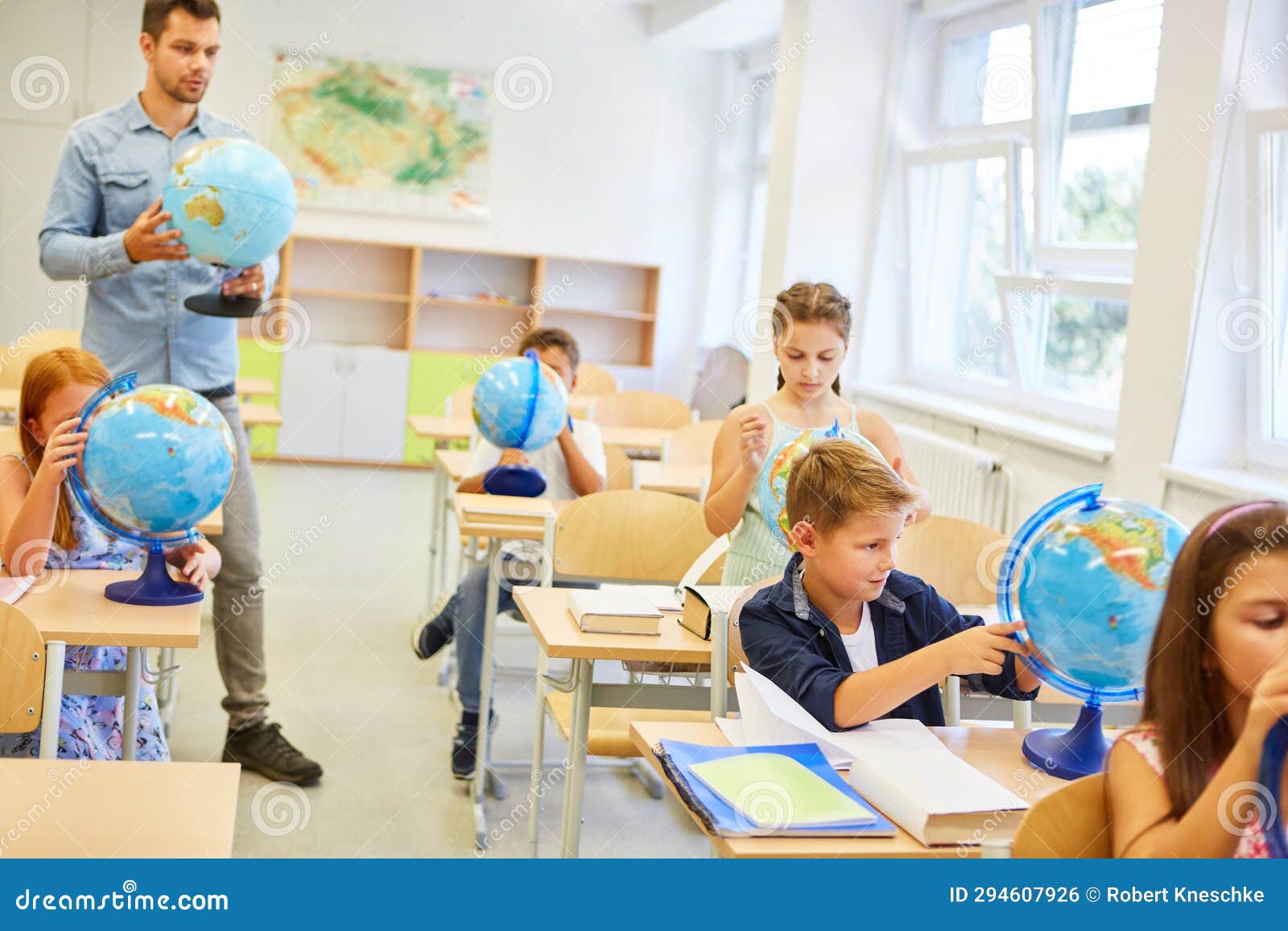 Teacher Teaching Students with Globe in Class Stock Photo - Image of ...