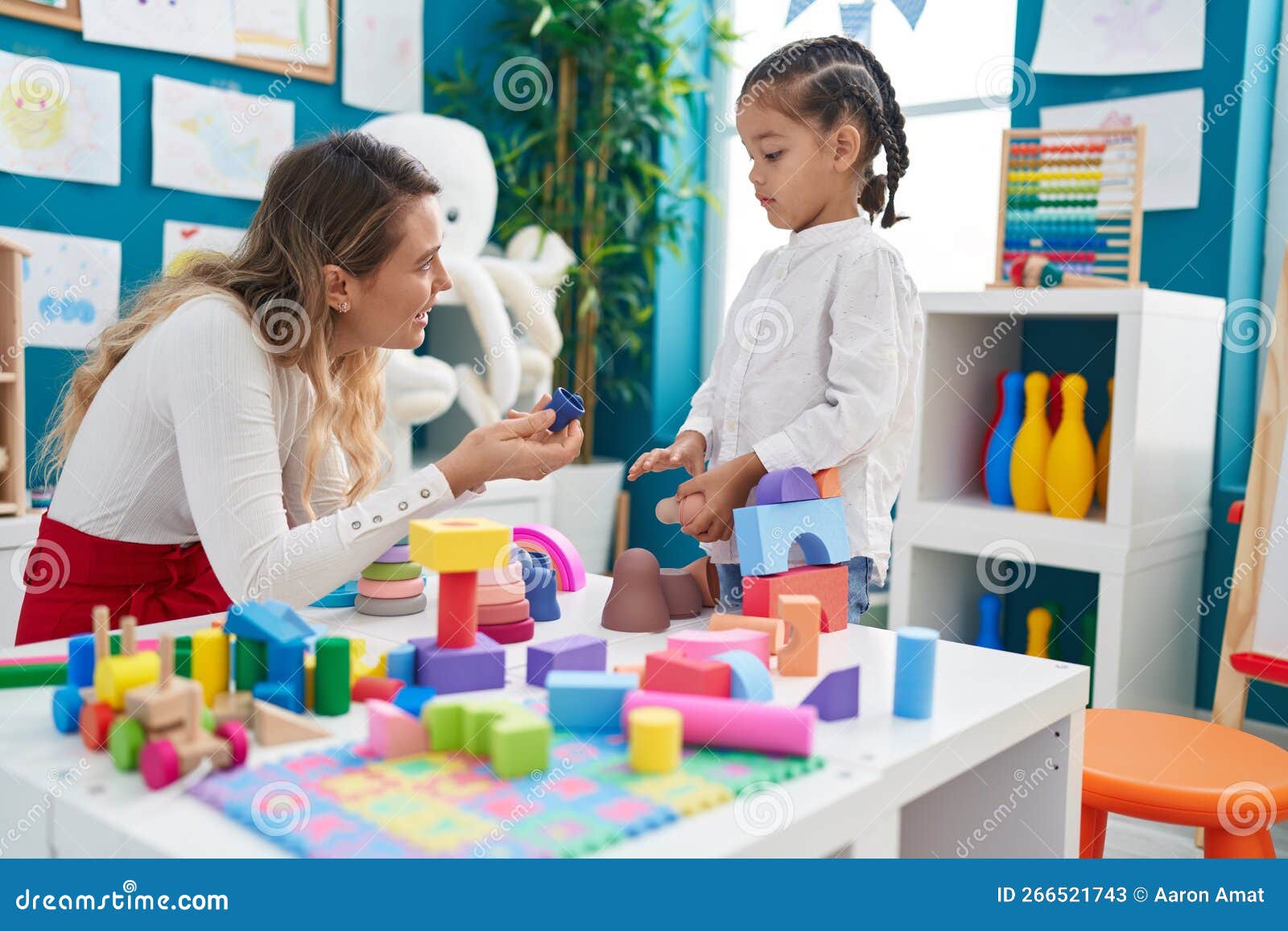 Teacher and Toddler Playing with Geometry Blocks Sitting on Table at ...