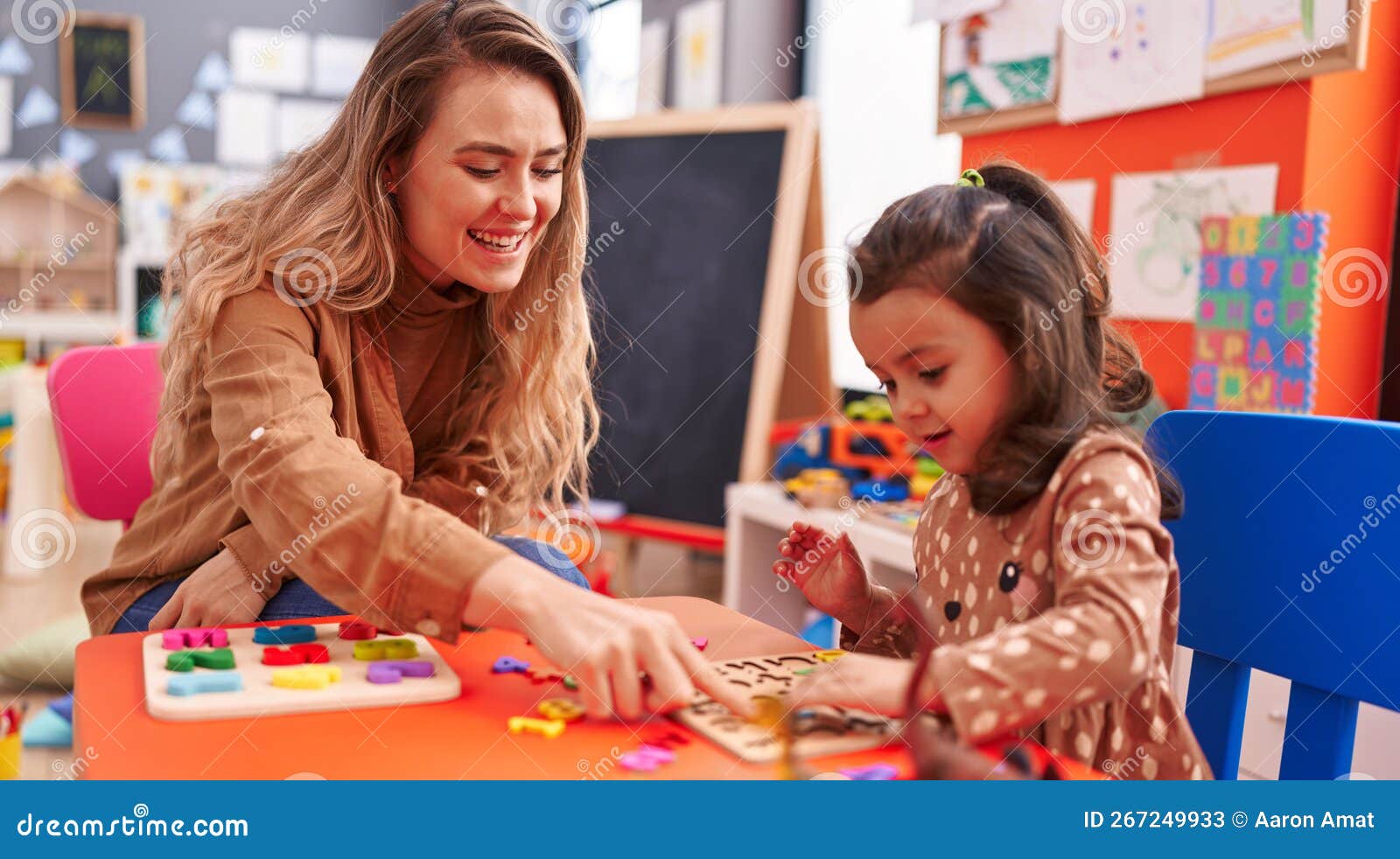 Teacher and Toddler Playing with Maths Puzzle Game Sitting on Table at ...