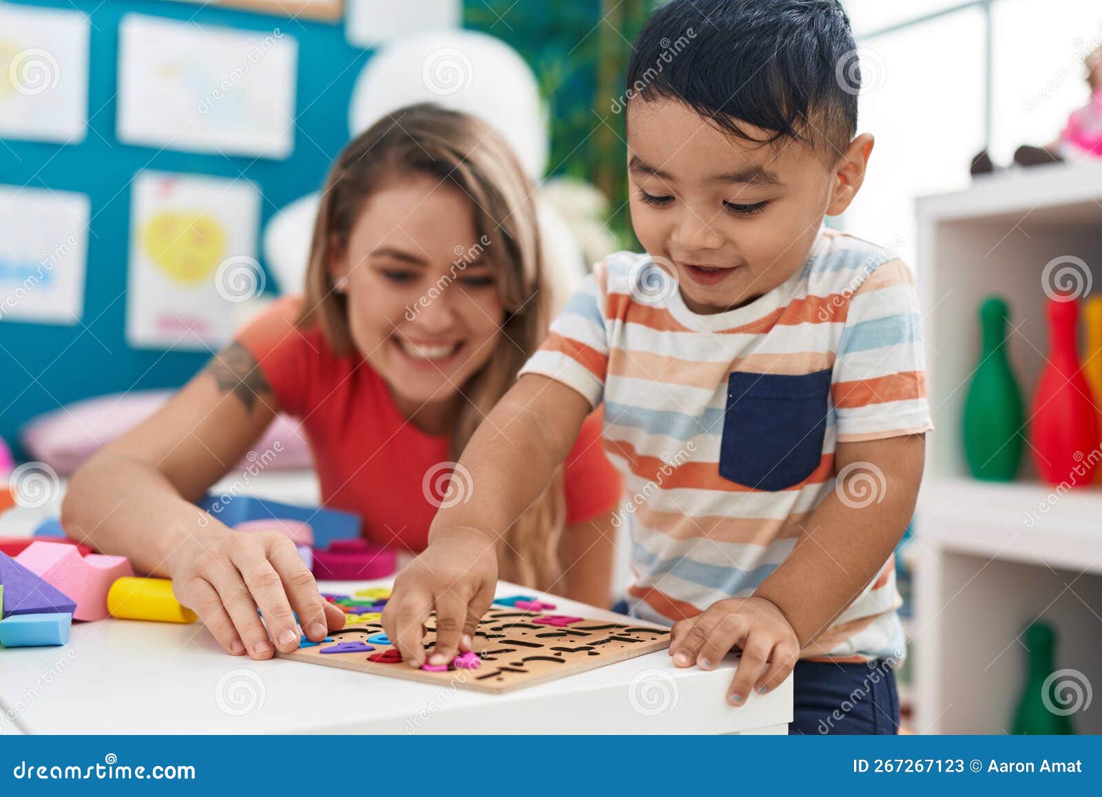 Teacher and Toddler Playing with Maths Puzzle Game Sitting on Table at ...
