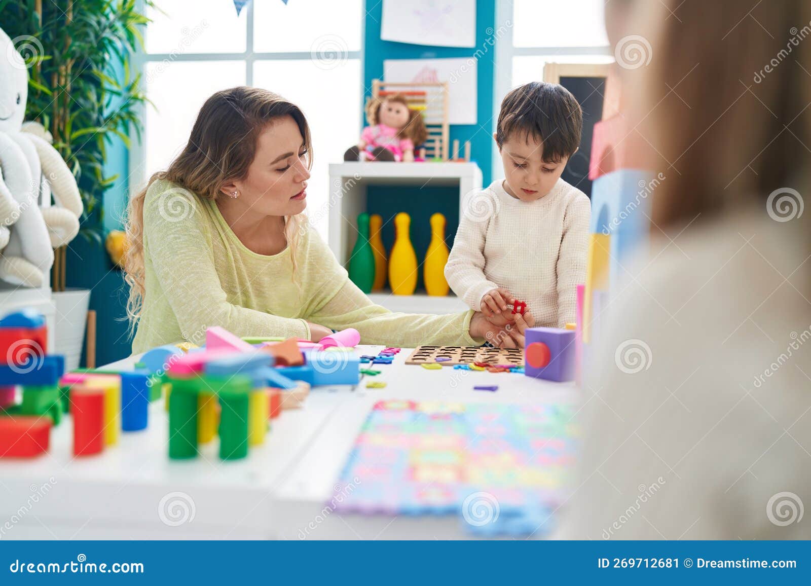 Teacher and Toddler Playing with Maths Puzzle Game Sitting on Table at ...