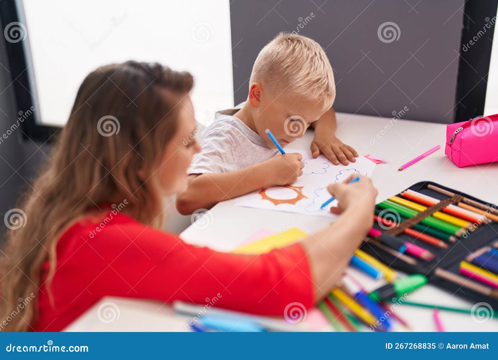 Teacher and Toddler Sitting on Table Drawing on Paper at Classroom ...