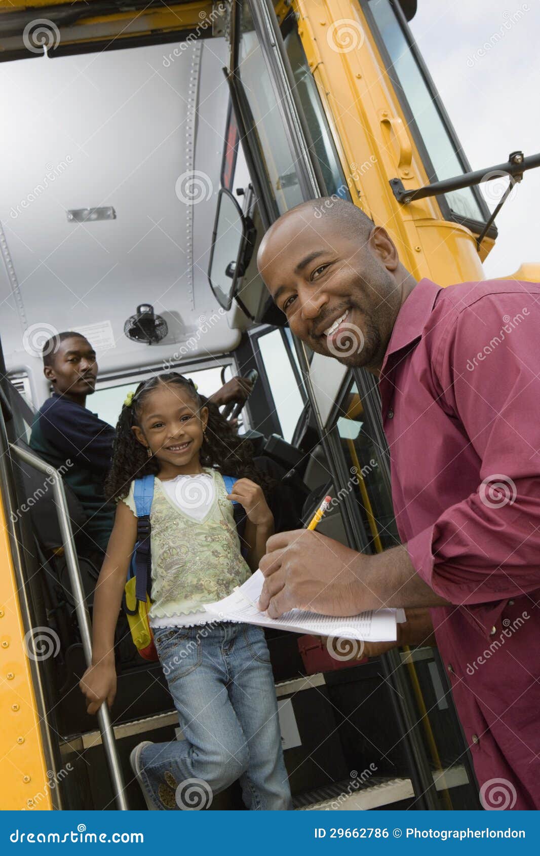 Teacher Unloading Elementary Students from School Bus Stock Photo ...