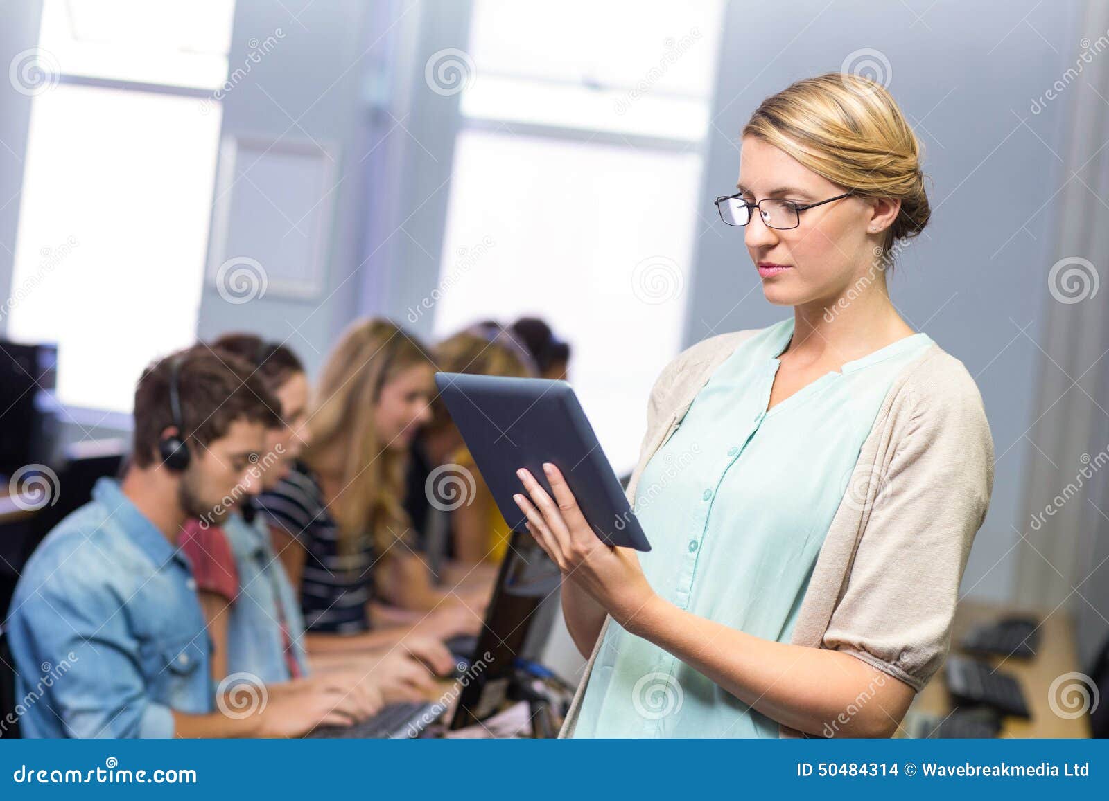 Teacher Using Digital Tablet in Computer Class Stock Photo - Image of ... Teacher Using Digital Tablet in Computer Class Stock Photo - Image of ...