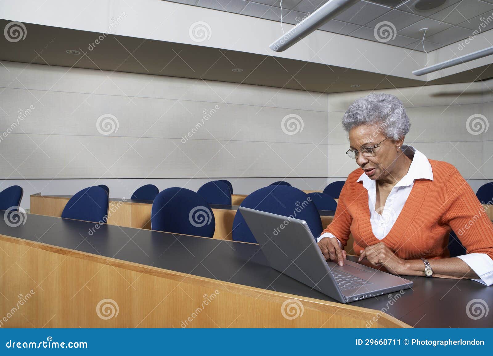 Teacher Using Laptop in Classroom Stock Image - Image of female, black ...