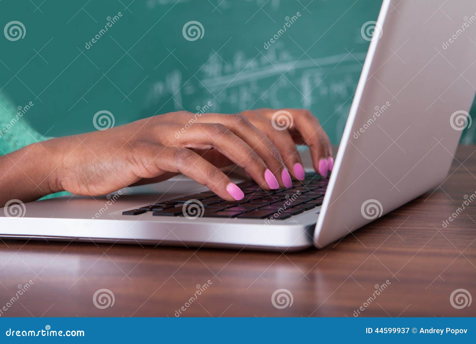 Teacher Using Laptop at Desk Stock Image - Image of school ...