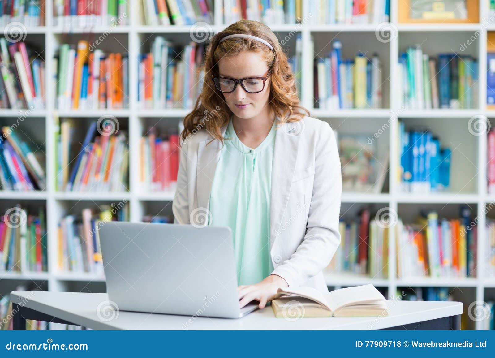 Teacher Using Laptop in Library Stock Photo - Image of internet, female ...