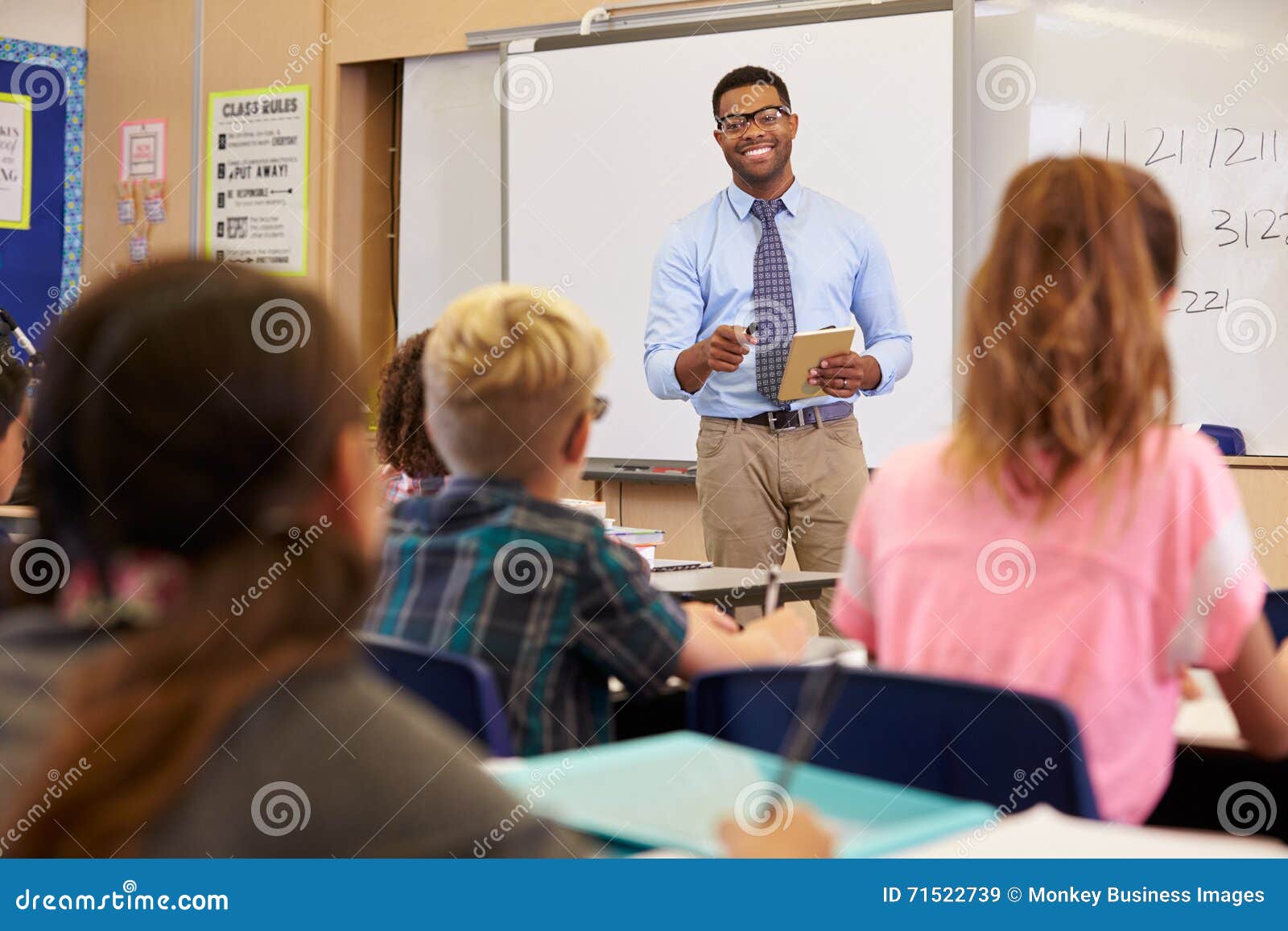 Teacher Using Tablet Computer in an Elementary School Class Stock Image ...