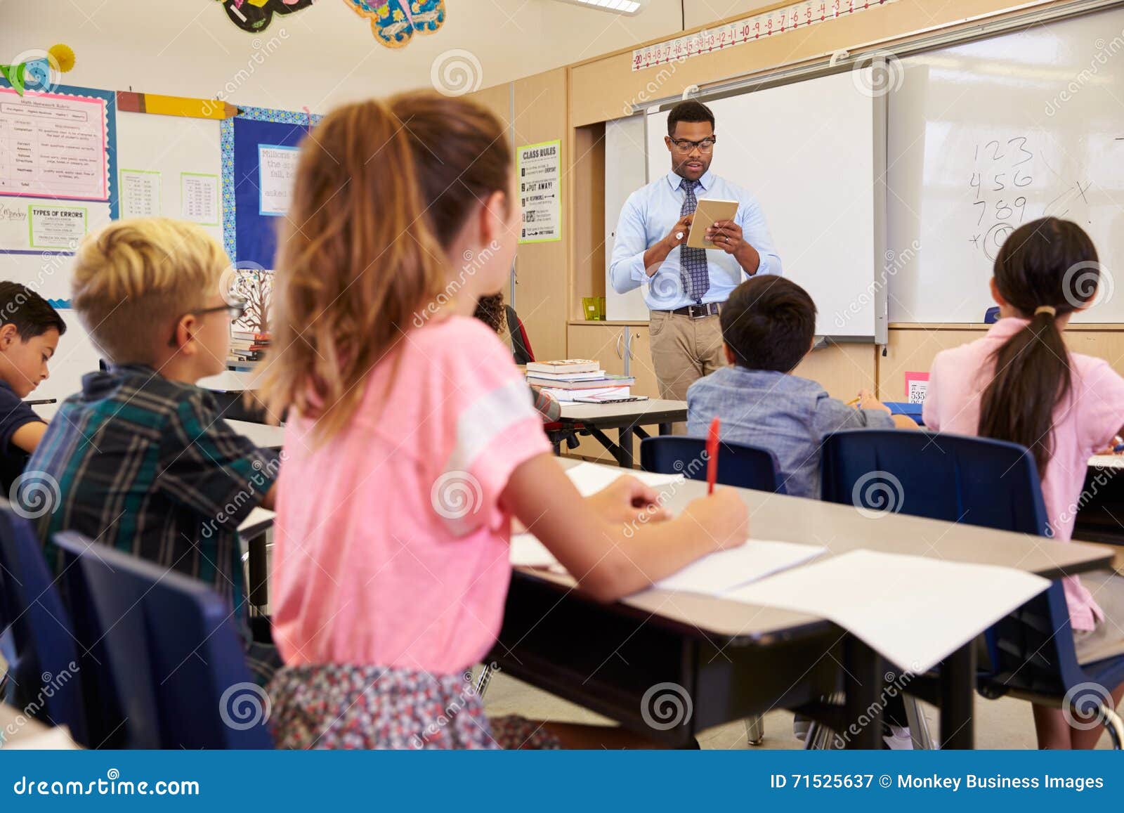 Teacher Using Tablet Computer in an Elementary School Class Stock Image ...
