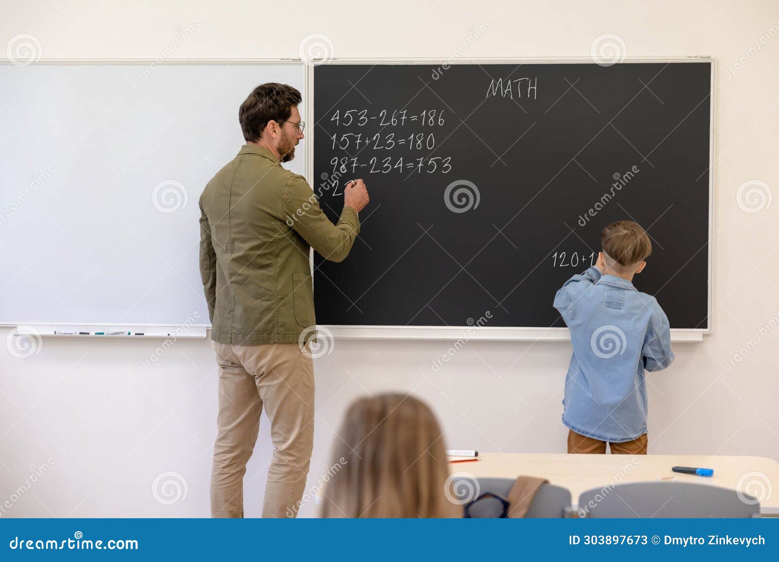 Teacher Working with Boy Pupil at Lesson Solving Math Tasks in ...