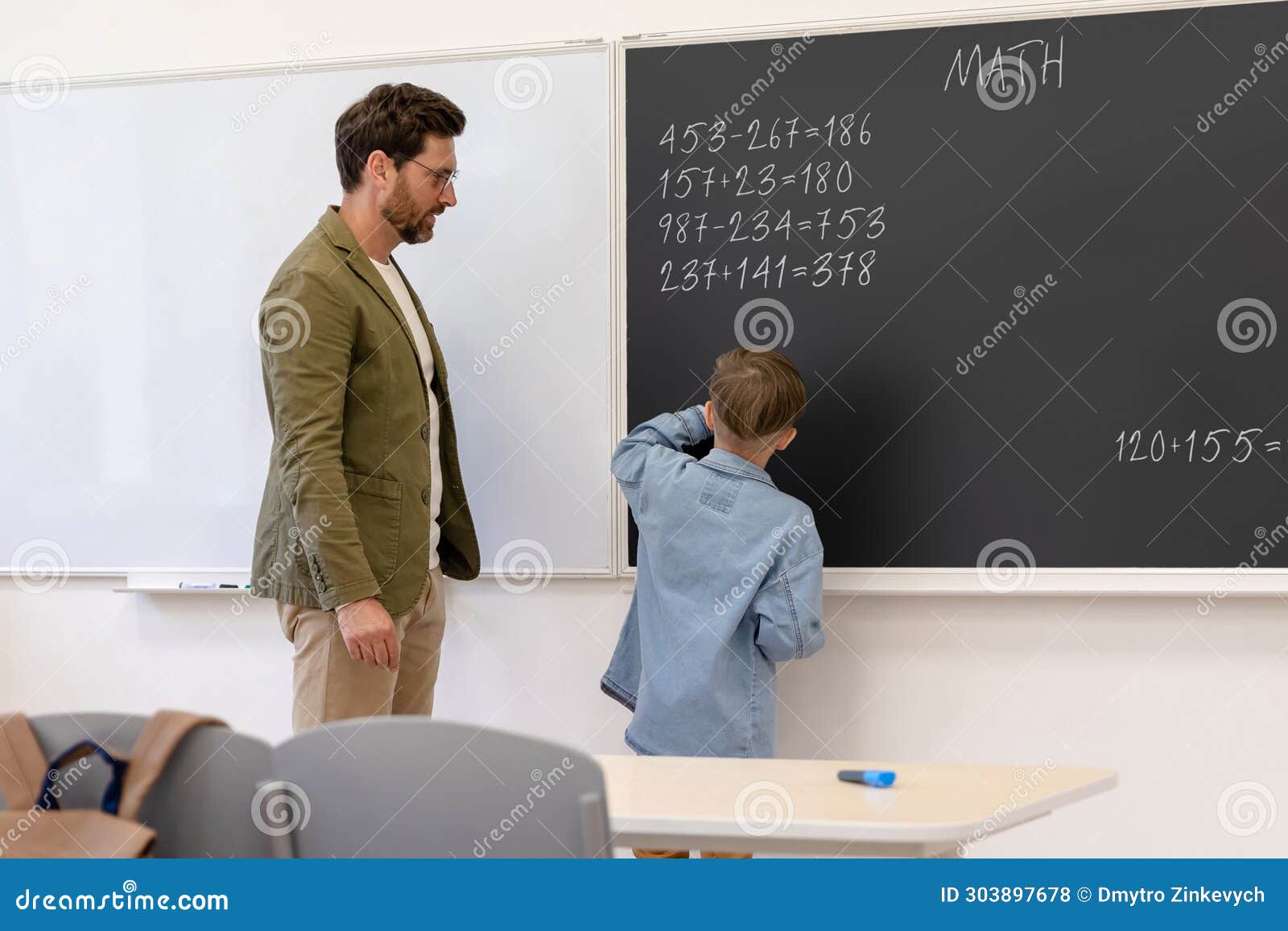 Teacher Working with Boy Pupil at Lesson Solving Math Tasks in ...