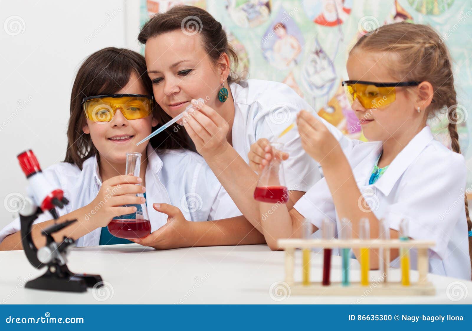 Teacher Working Close with the Elementary Science Class Students Stock ...