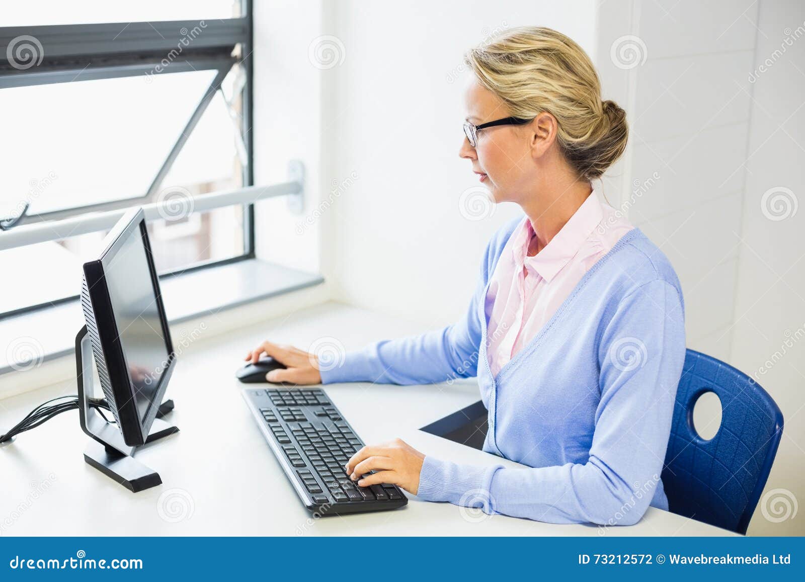 Teacher Working on Computer in Classroom Stock Photo - Image of ...