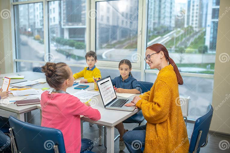 Teacher Working with a Small Group of Kids Stock Photo - Image of nice ...
