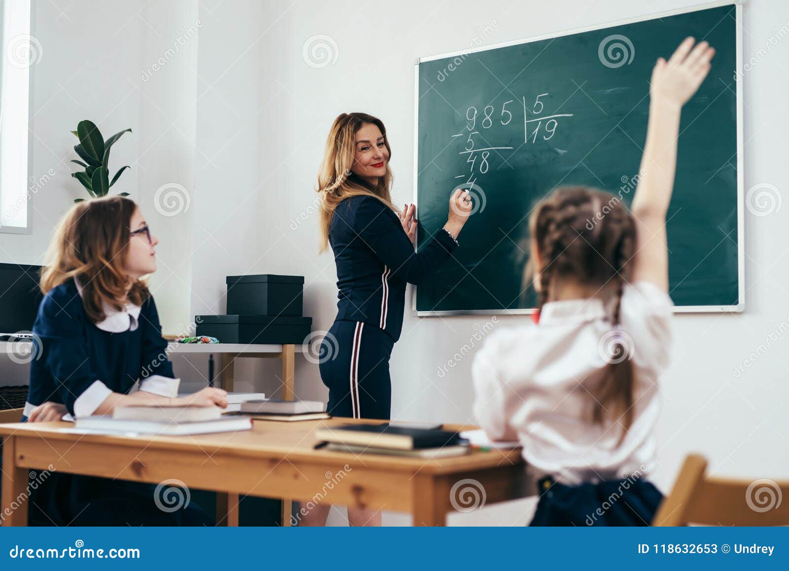 Teacher Writes a Mathematical Example on the Chalkboard Stock Image ...