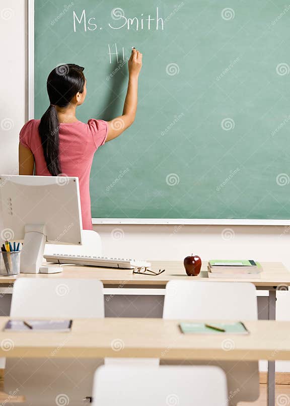 Teacher Writing on Chalk Board in Classroom Stock Image - Image of ...