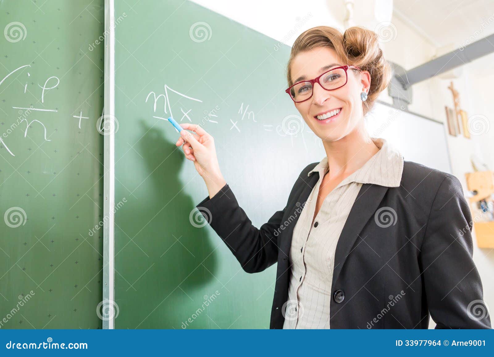 Teacher Writing with Chalk in Front of School Class on Board Stock ...