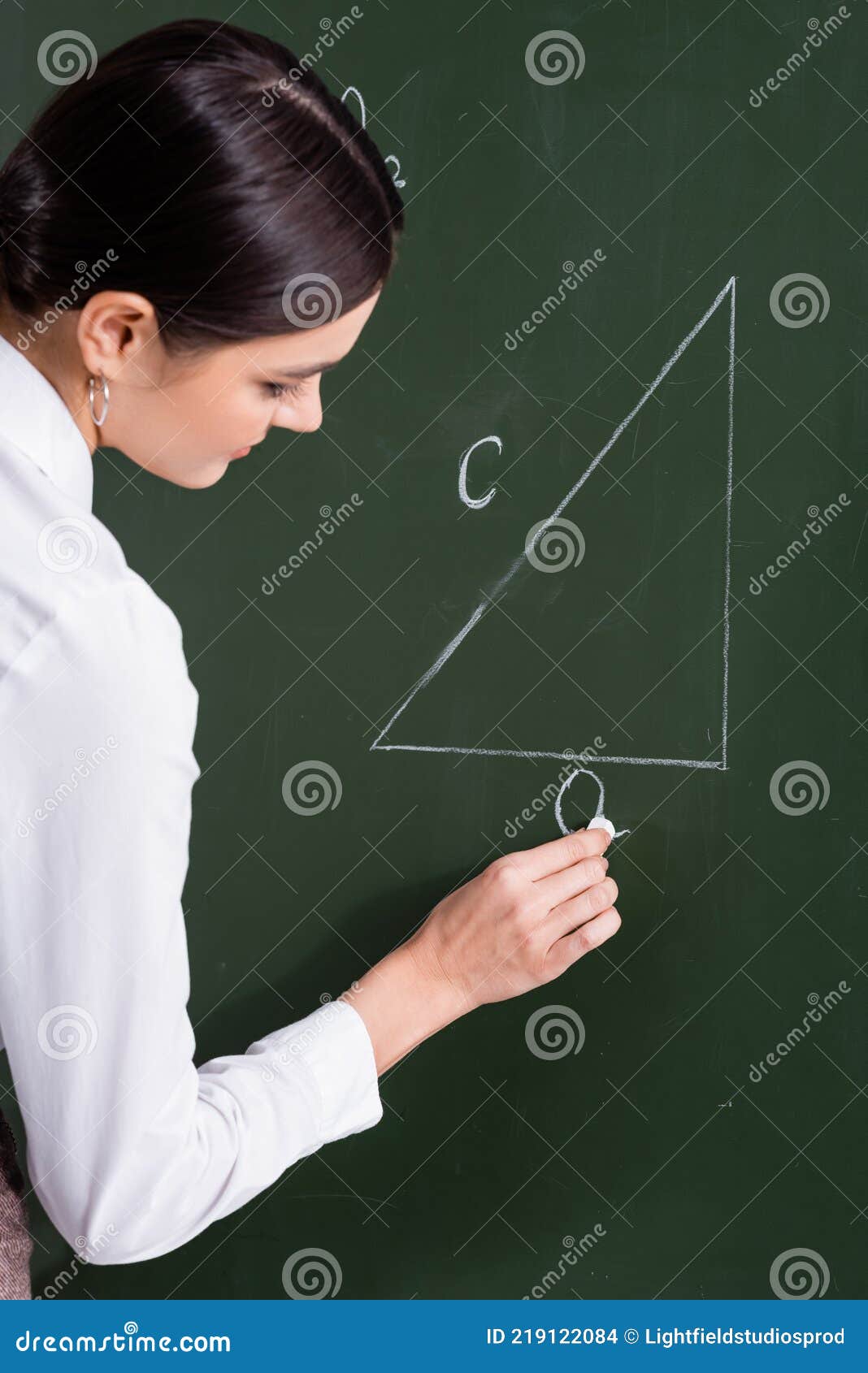 Teacher Writing Triangle on Chalkboard in Stock Photo - Image of ...