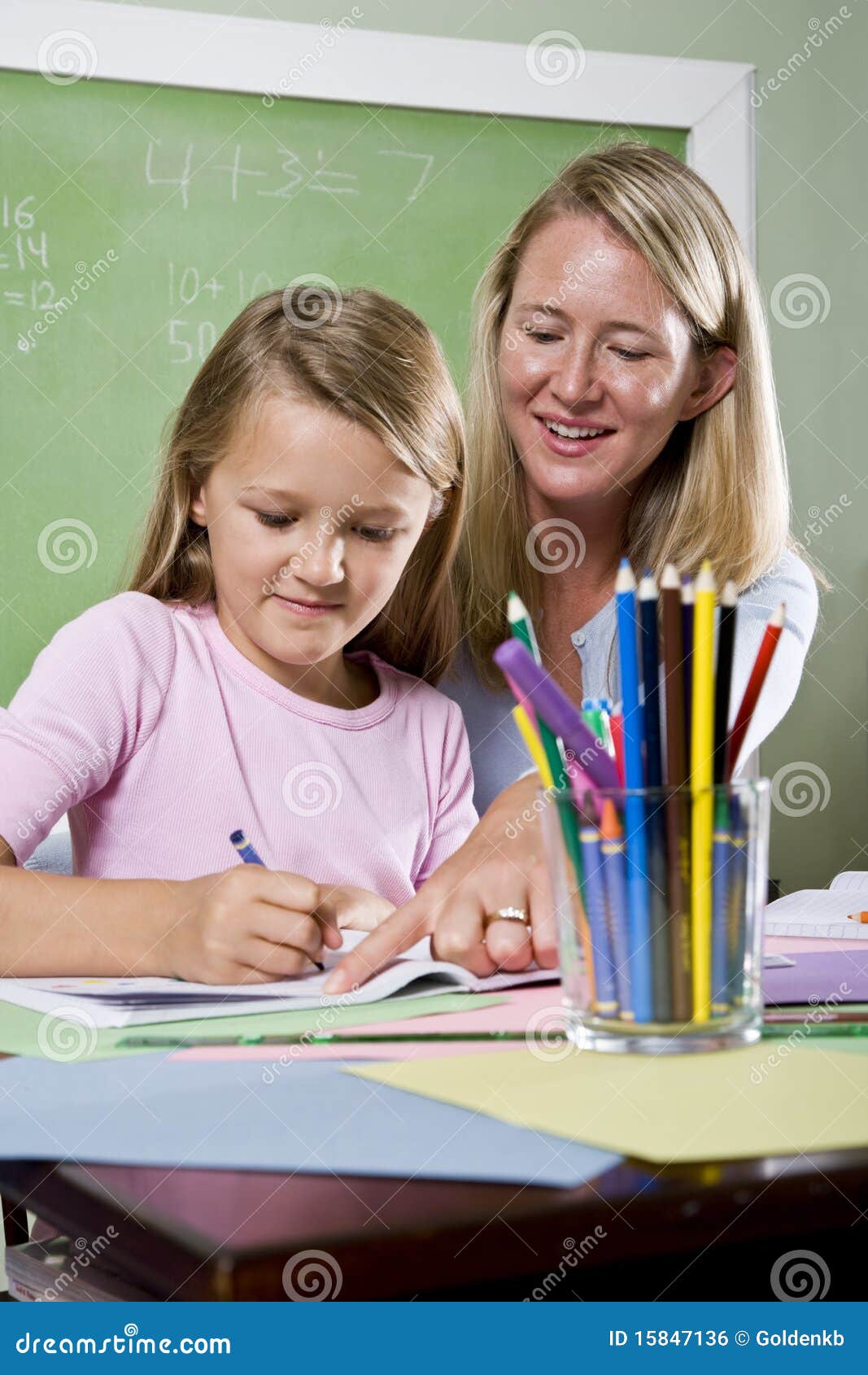 Teacher and Young Student in Class Writing Stock Photo - Image of ...
