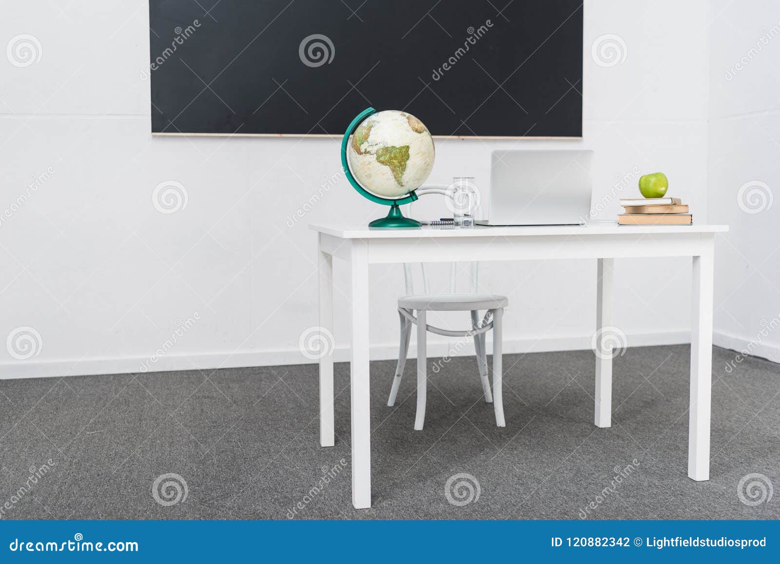 Teachers Desk in Classroom in Front Stock Photo - Image of globe ...