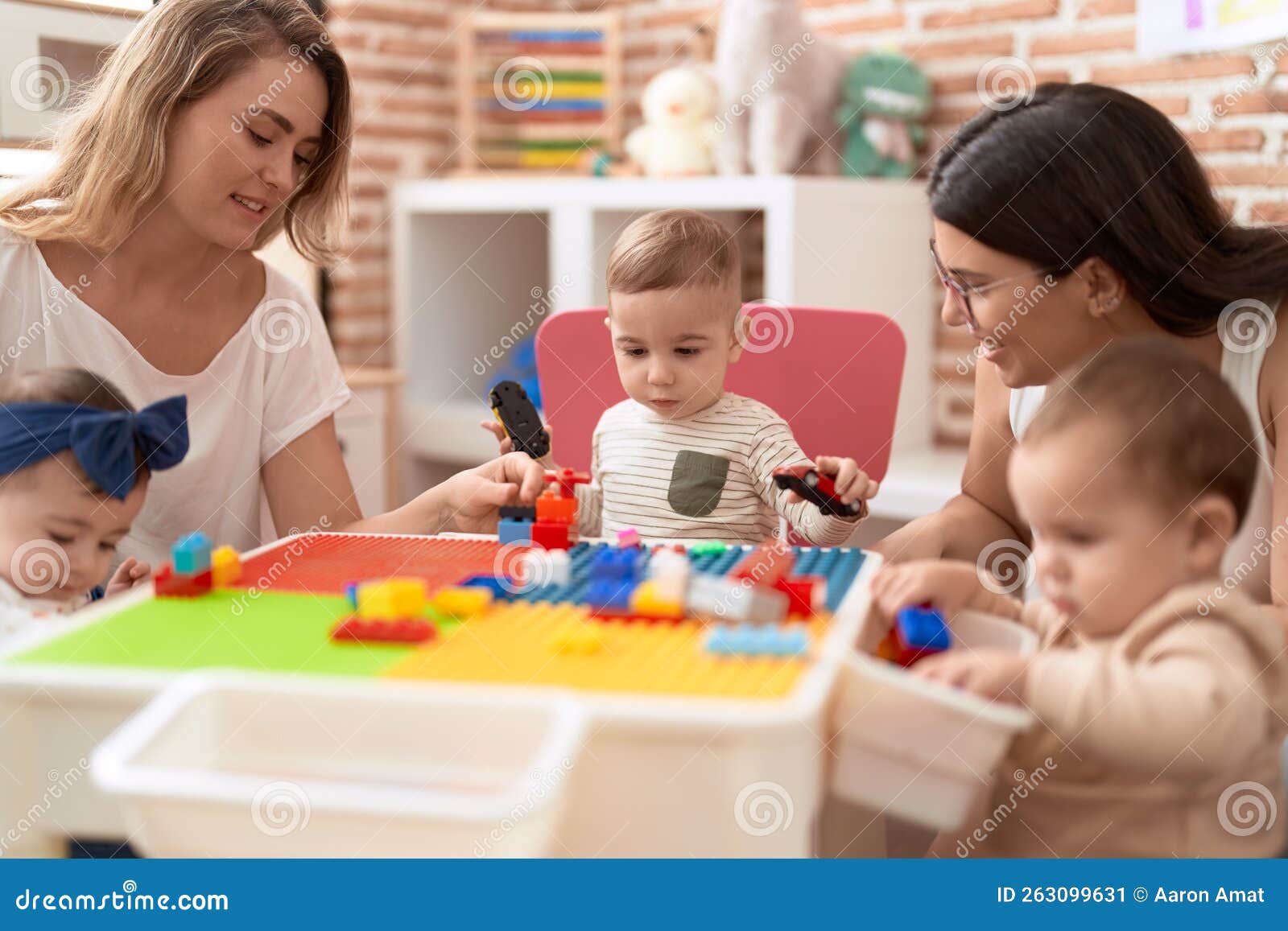 Teachers and Preschool Students Playing with Construction Blocks ...
