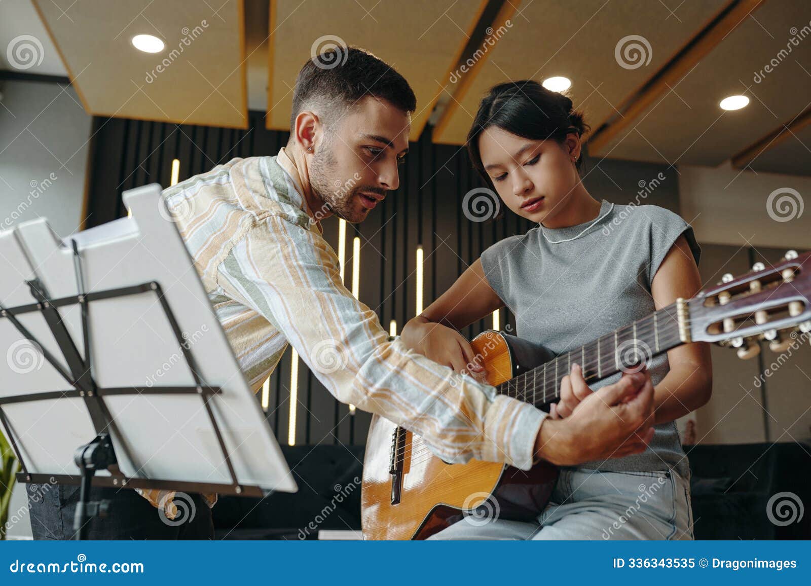 Teaching Guitar To Enthusiastic Student in Modern Classroom Stock Image ...