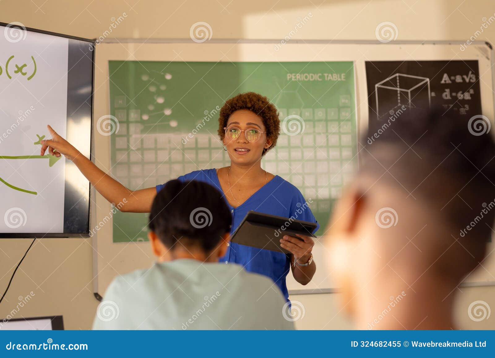 Teaching in High School, Teacher Using Tablet and Pointing at ...