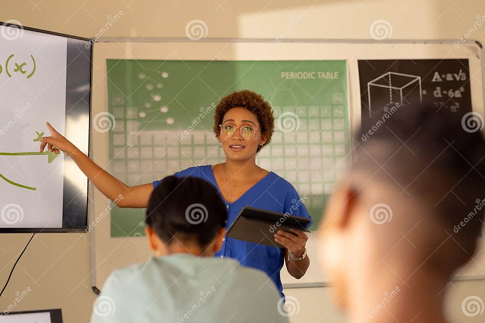 Teaching in High School, Teacher Using Tablet and Pointing at ...