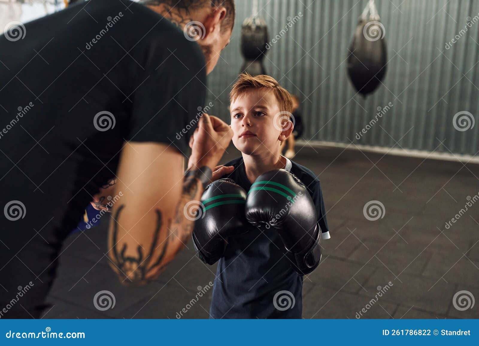 Teaching How To Punch. Coach is with Boy Showing Box Techniques Indoors ...