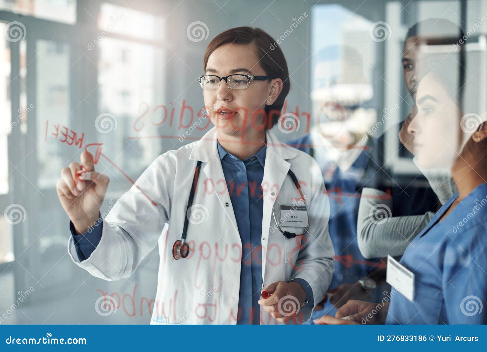 Teaching Hungry Minds. Shot a Group of Doctors Discussing Formulas in ...