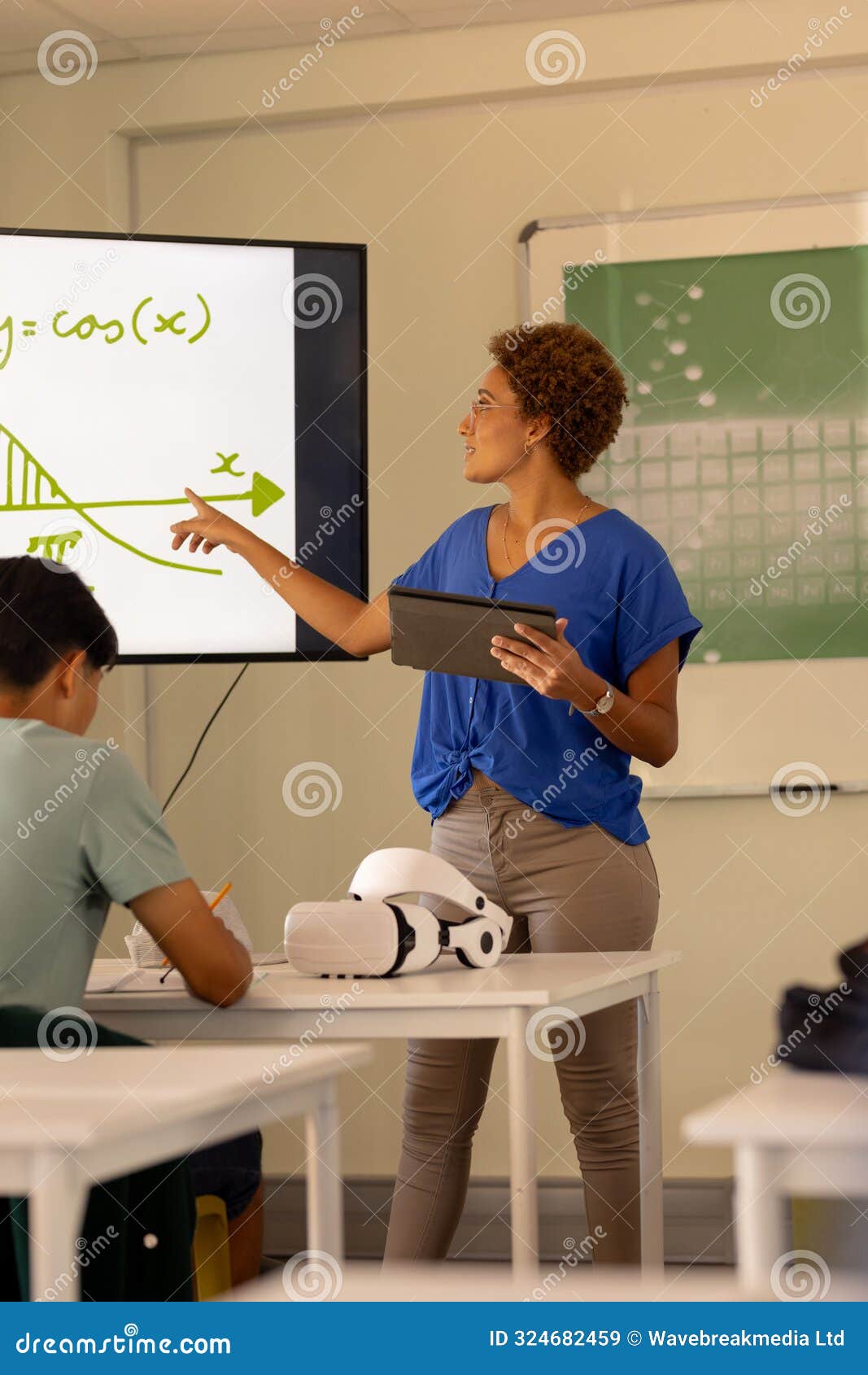 Teaching Math, Teacher Using Tablet and Pointing at Screen in High ...
