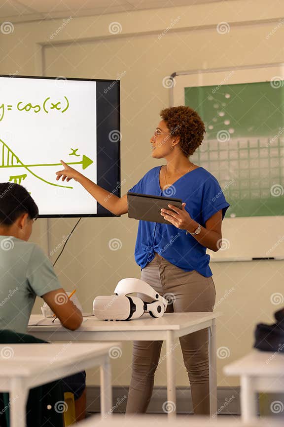 Teaching Math, Teacher Using Tablet and Pointing at Screen in High ...