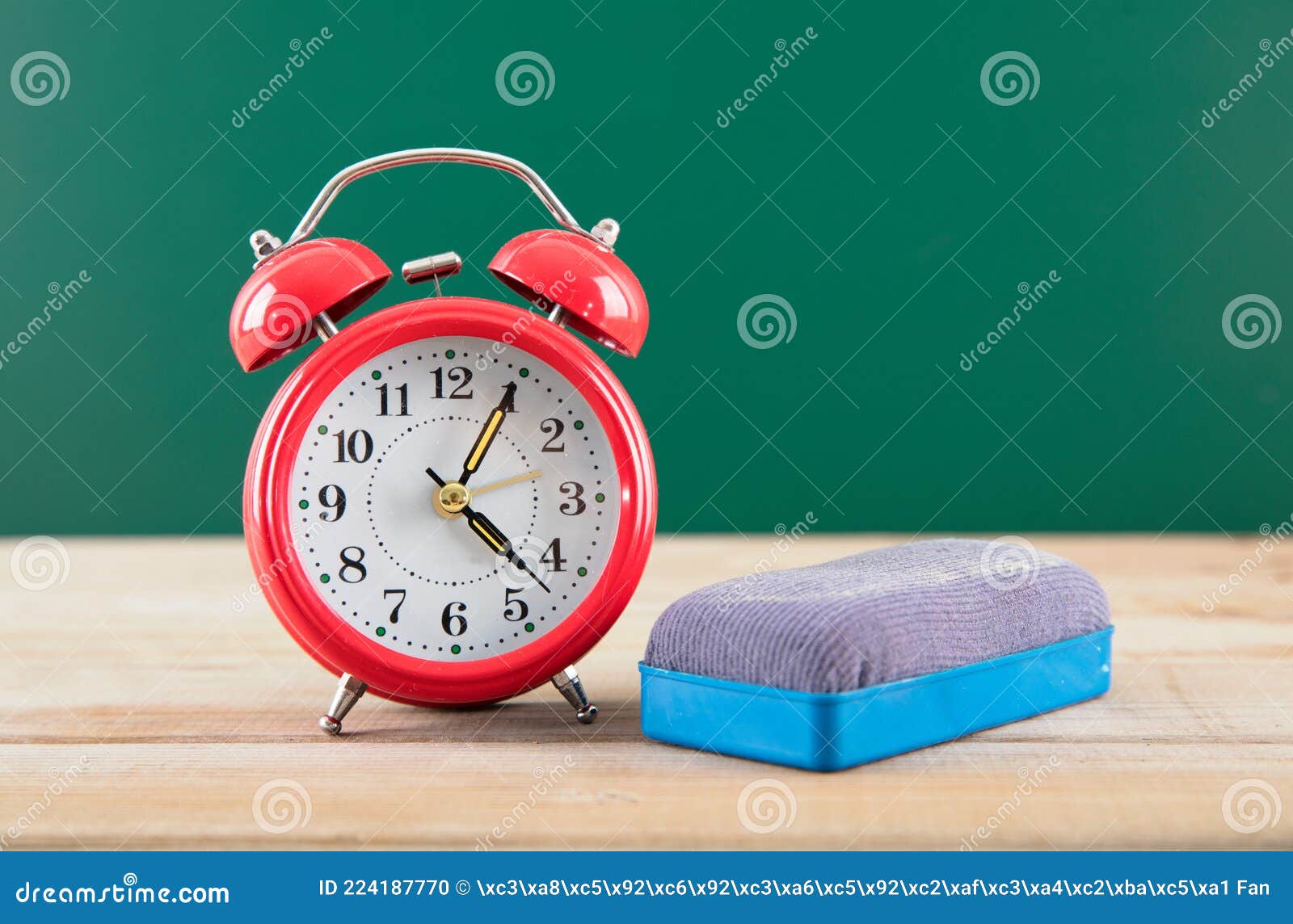 Teaching a Red Alarm Clock and a Blackboard Eraser in Front of the ...