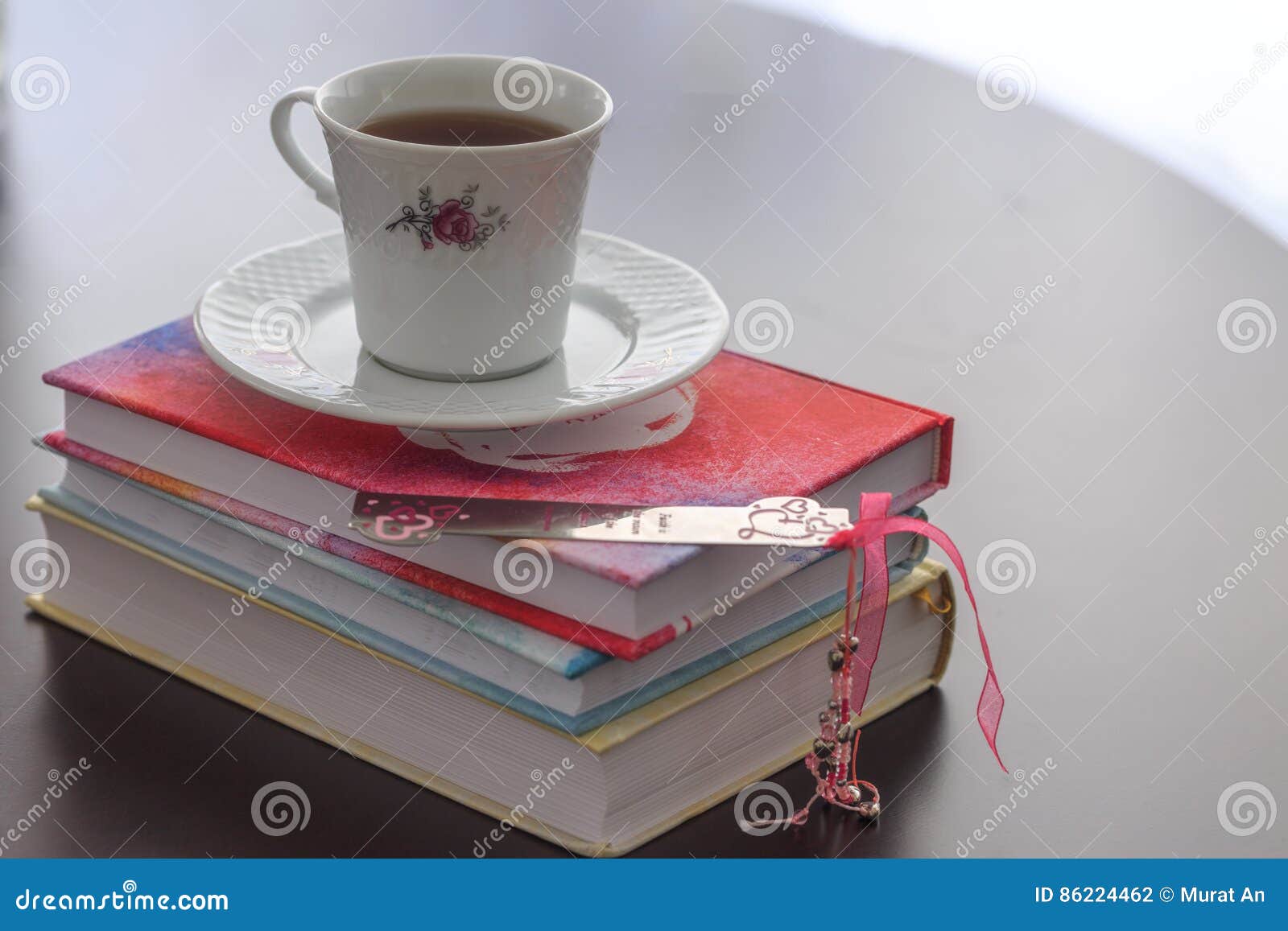 Teacup on Books with Pink Bookmark Stock Photo - Image of dark, pages ...