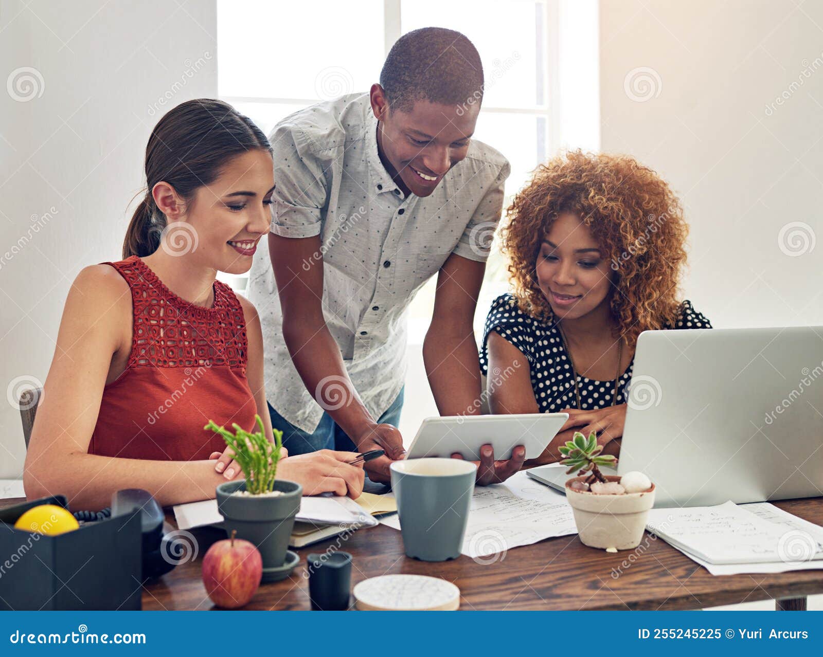 The Team in Action. a Group of Colleagues Working Together at a Desk in ...