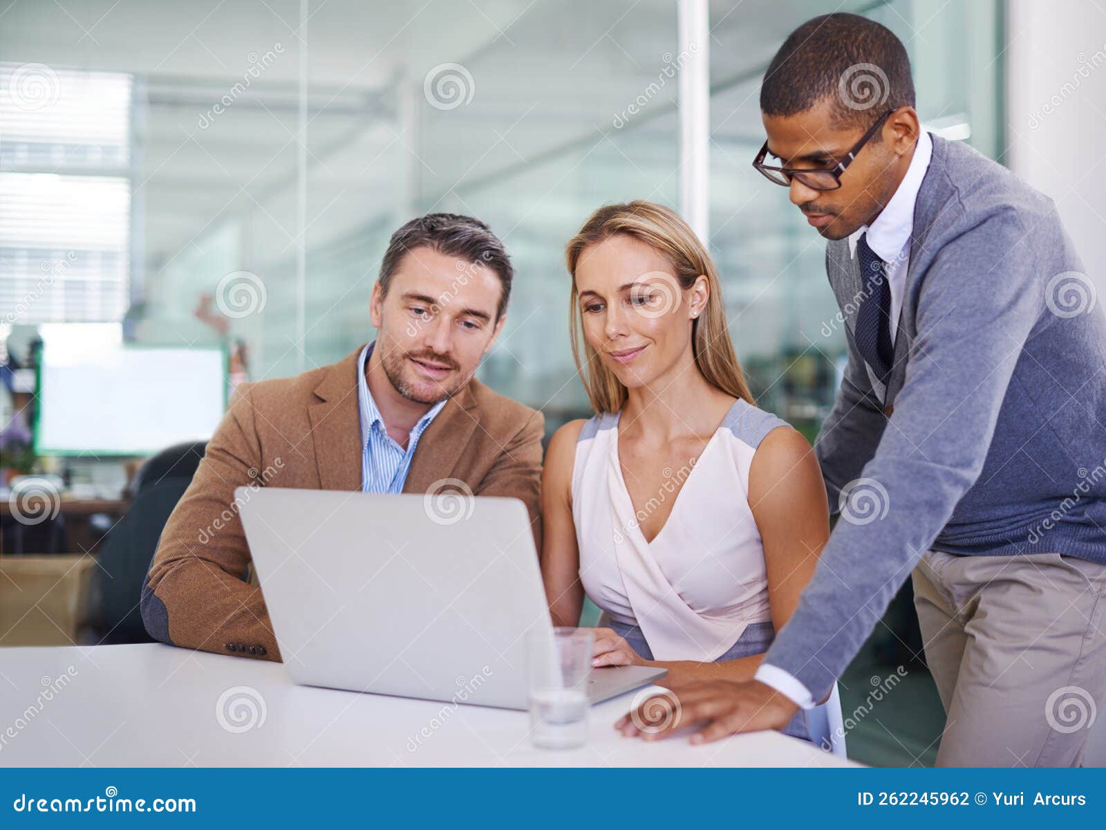 This Team is All about Efficiency. Three Colleagues Using a Laptop To ...