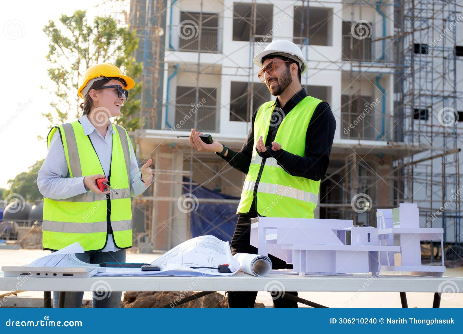 Team Architect and Builder Talking and Holding Model House at ...