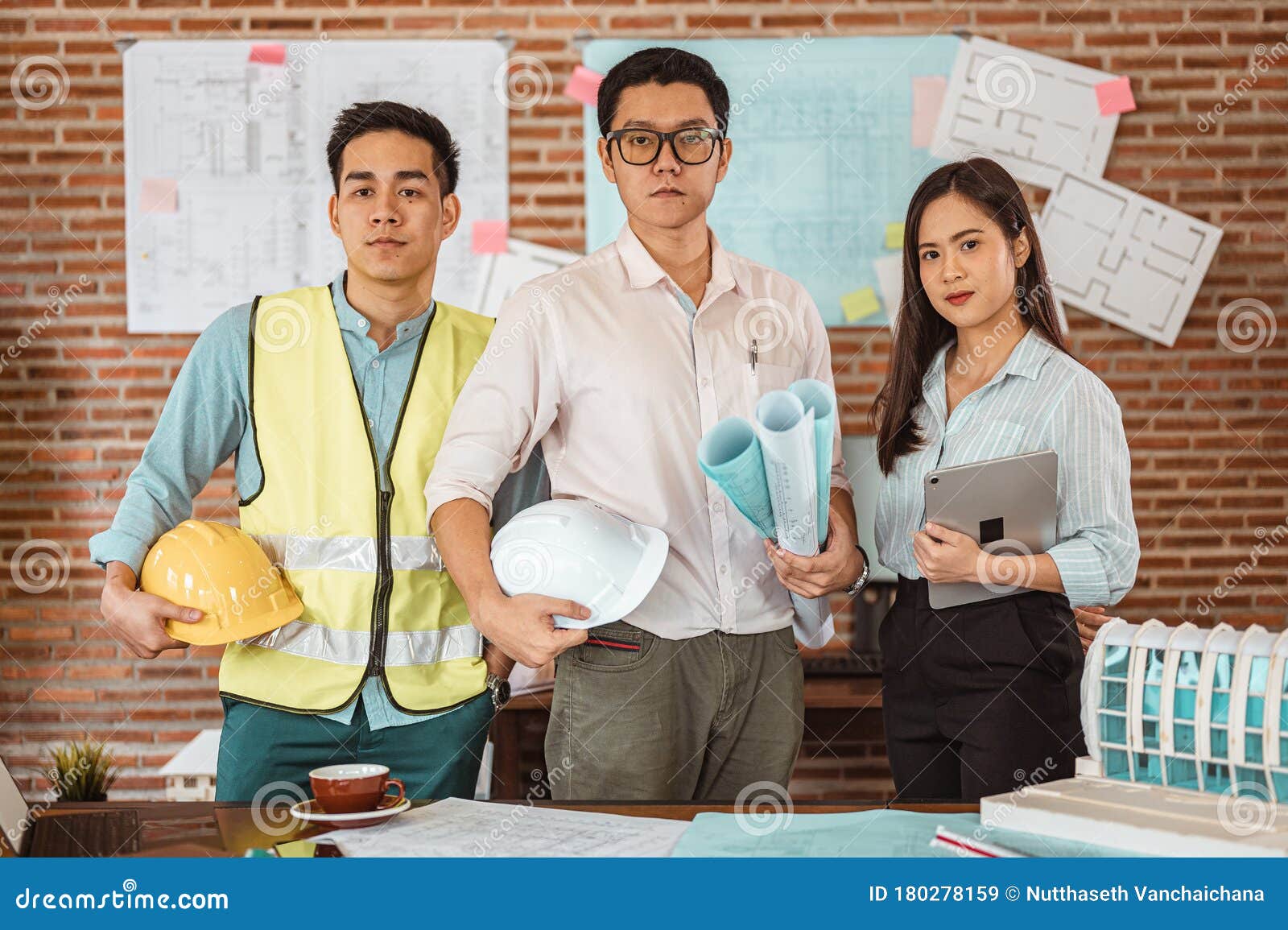 Team of Architect are Holding on Blueprint and Helmet Working ...