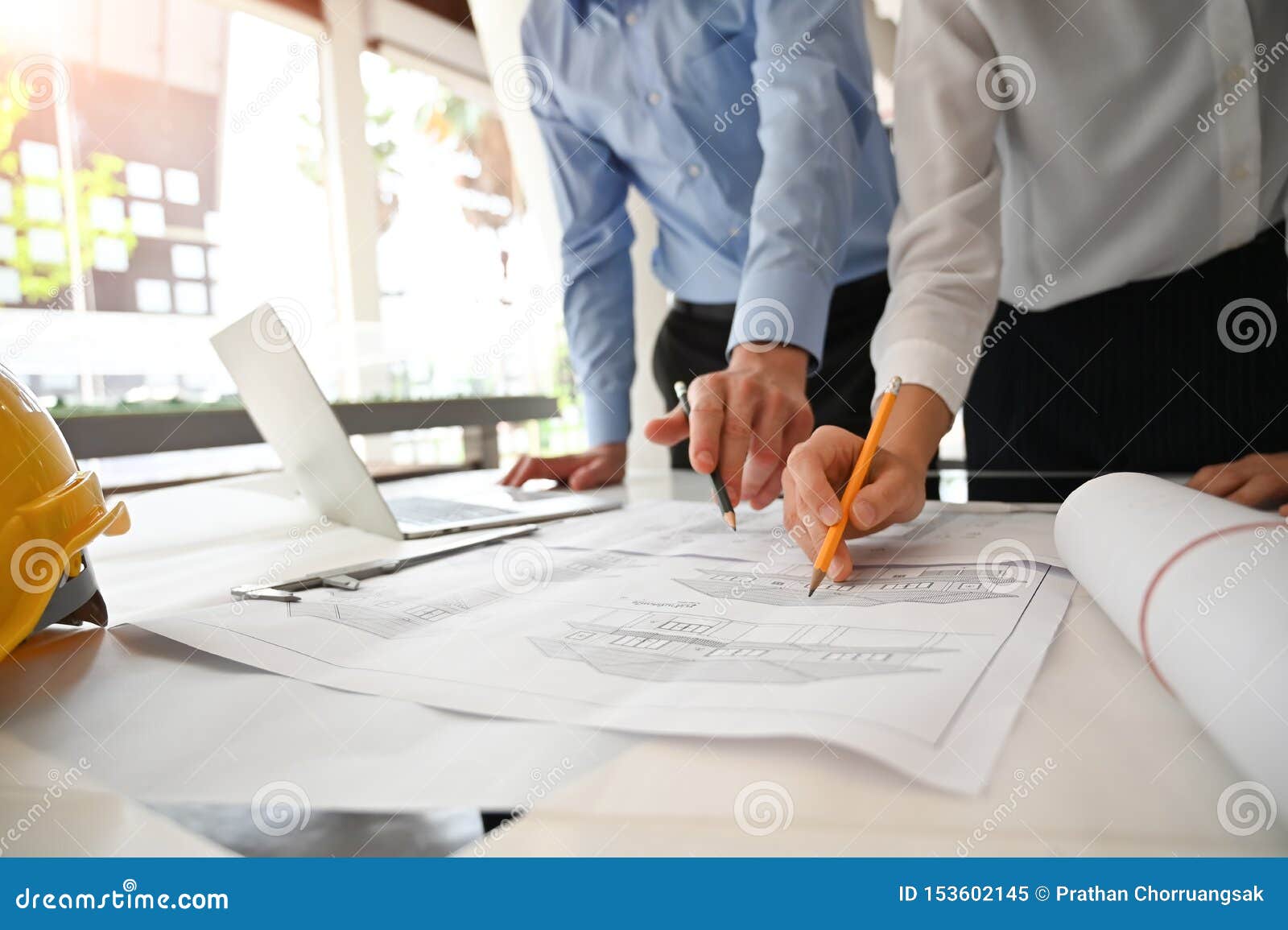 Team Architect Meeting and Consult with Blueprint and Computer in ...