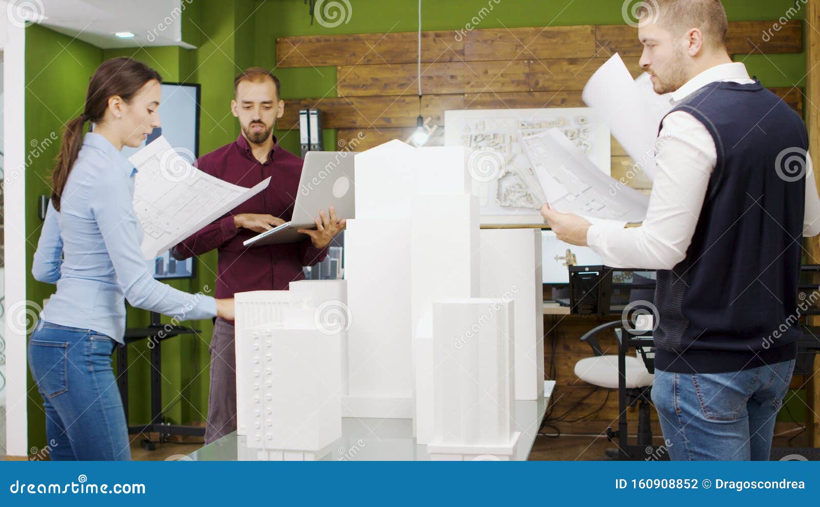 Team of Architect Working on a Building Project with Building Models ...