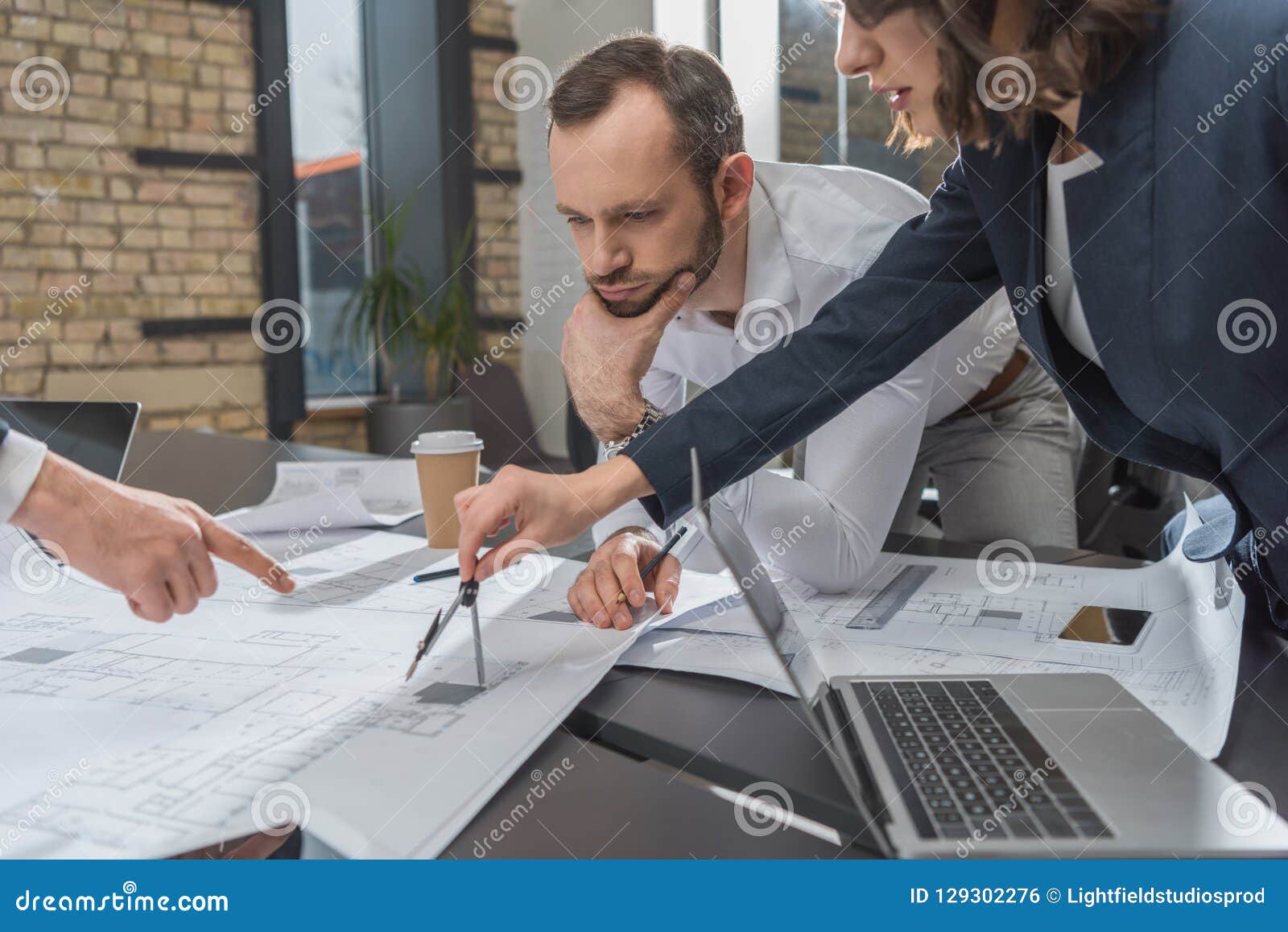 Team of Architects Measuring Building Plans with Compass Together Stock ...