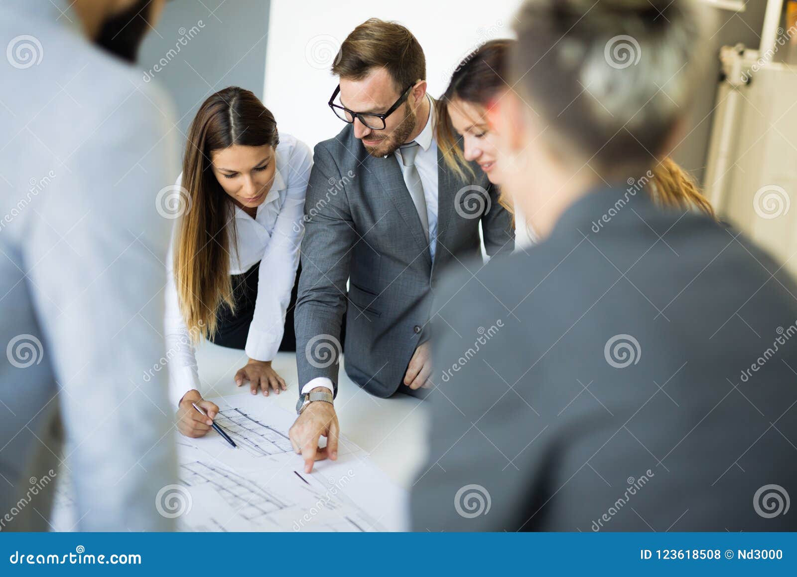 Team of Architects Working on Construction Plans Stock Photo - Image of ...