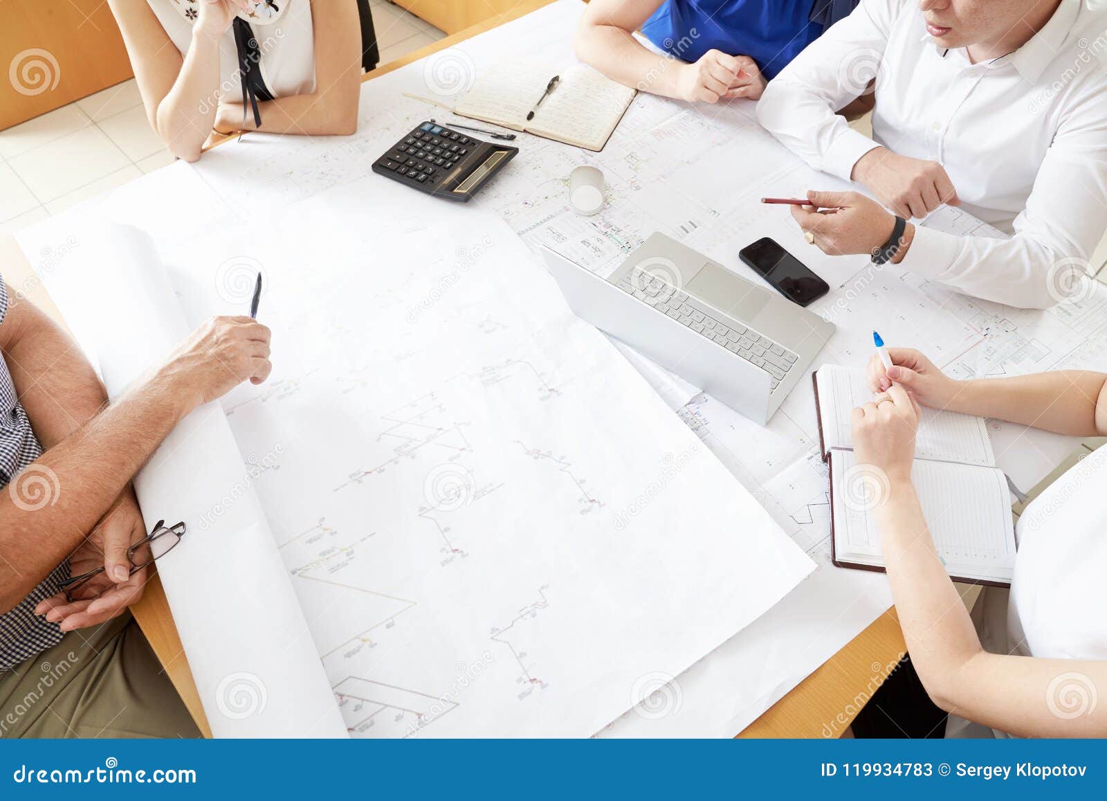 A Team of Architects Working with Drawings in the Office. Stock Image ...