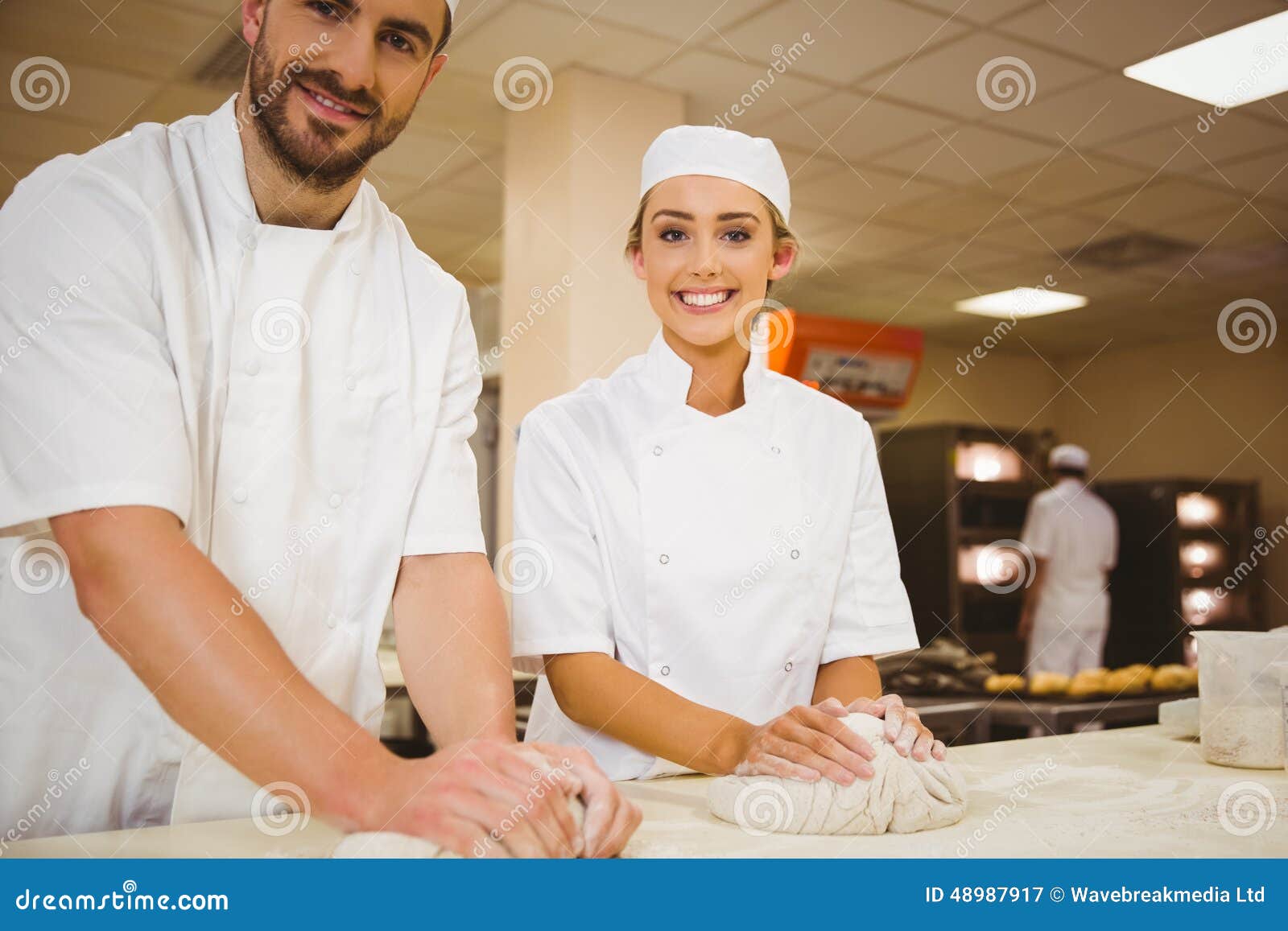 Team of Bakers Kneading Dough Stock Image - Image of standing, adult ...