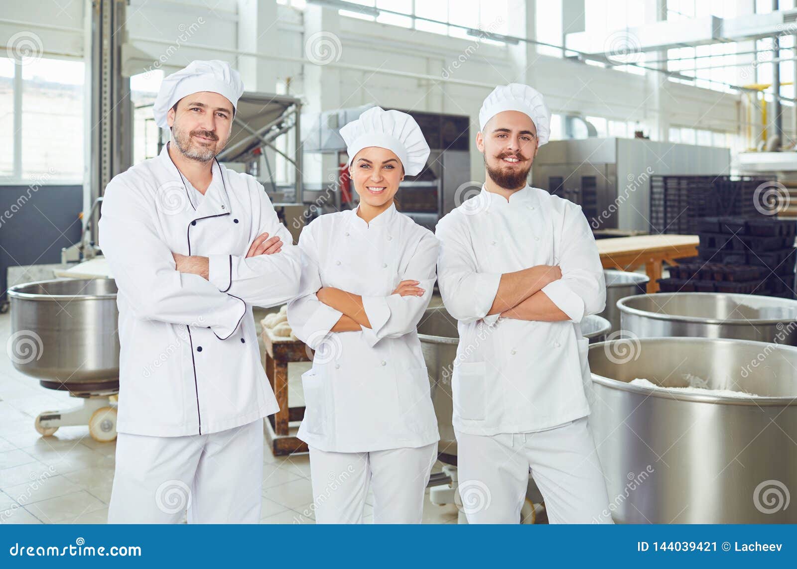 A Team of Bakers Smiles at the Bakery. Stock Image - Image of chefs ...
