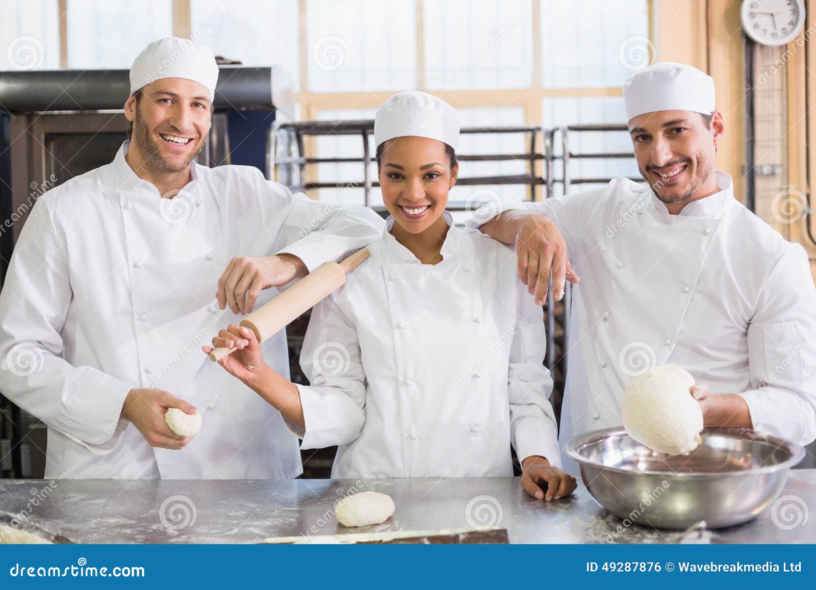 Team of Bakers Smiling at Camera Stock Photo - Image of kitchen ...