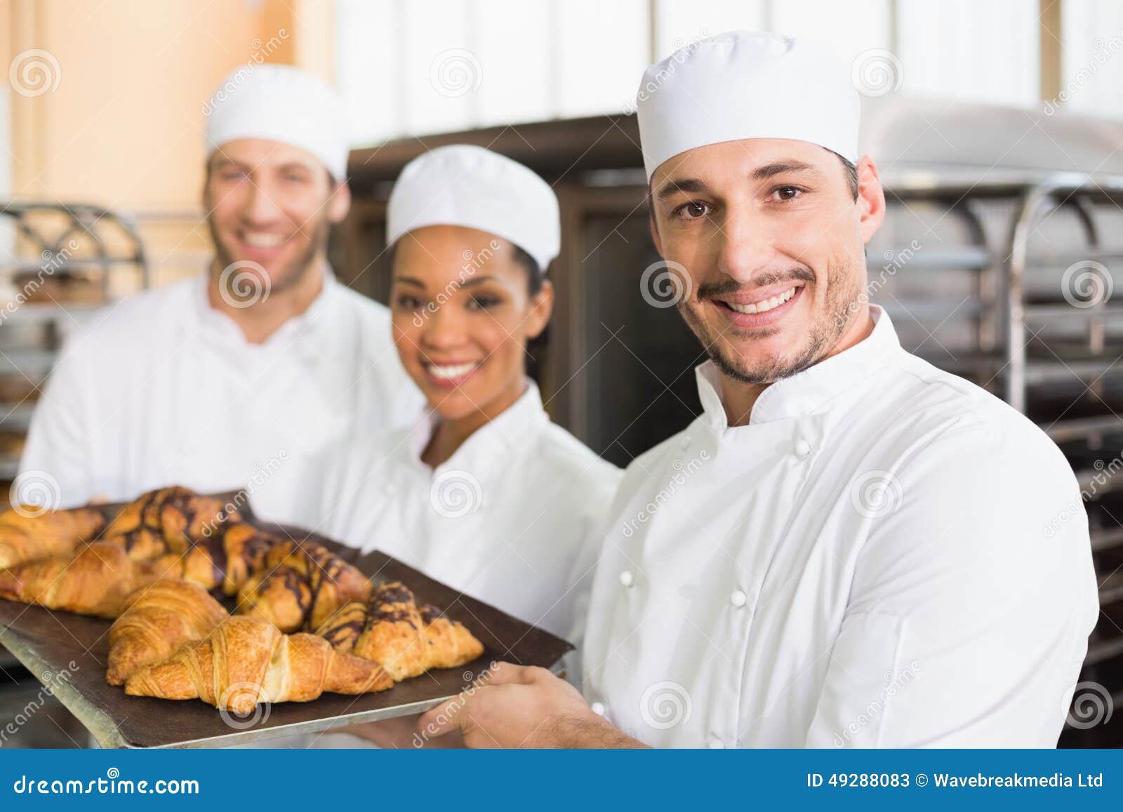 Team of Bakers Smiling at Camera with Trays of Croissants Stock Image ...