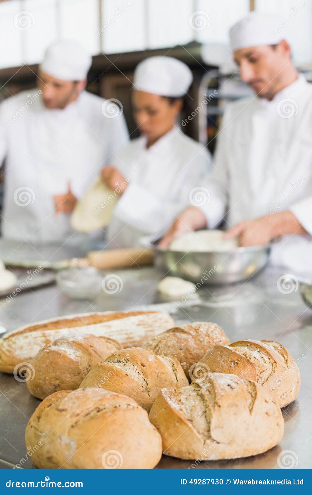 Team of Bakers Working at Counter Stock Photo - Image of female, bread ...